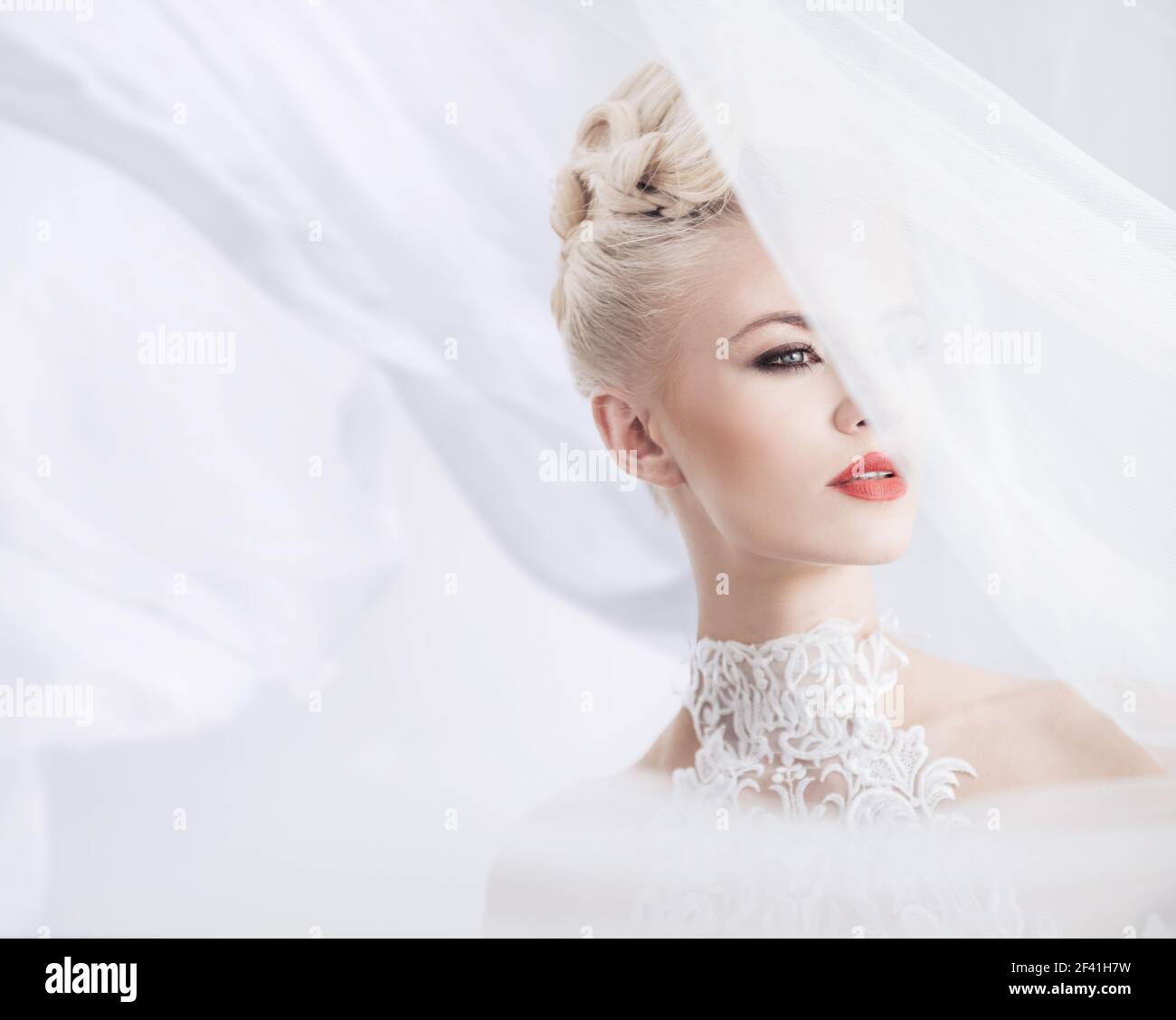 Elegant blond woman with a bright veil on the head Stock Photo - Alamy
