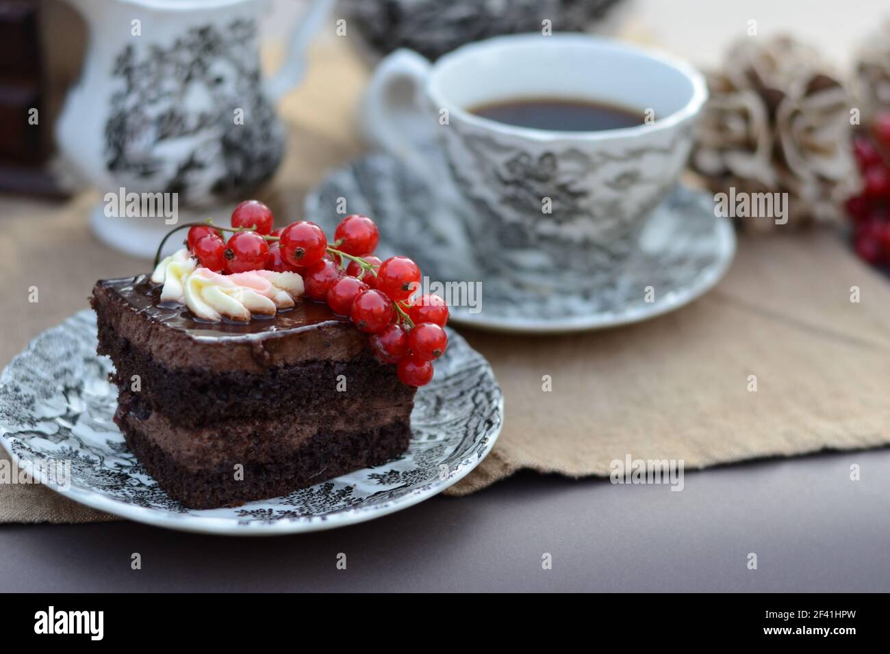 Chocolate pastry with fresh fruit served with a cup of black coffee ...