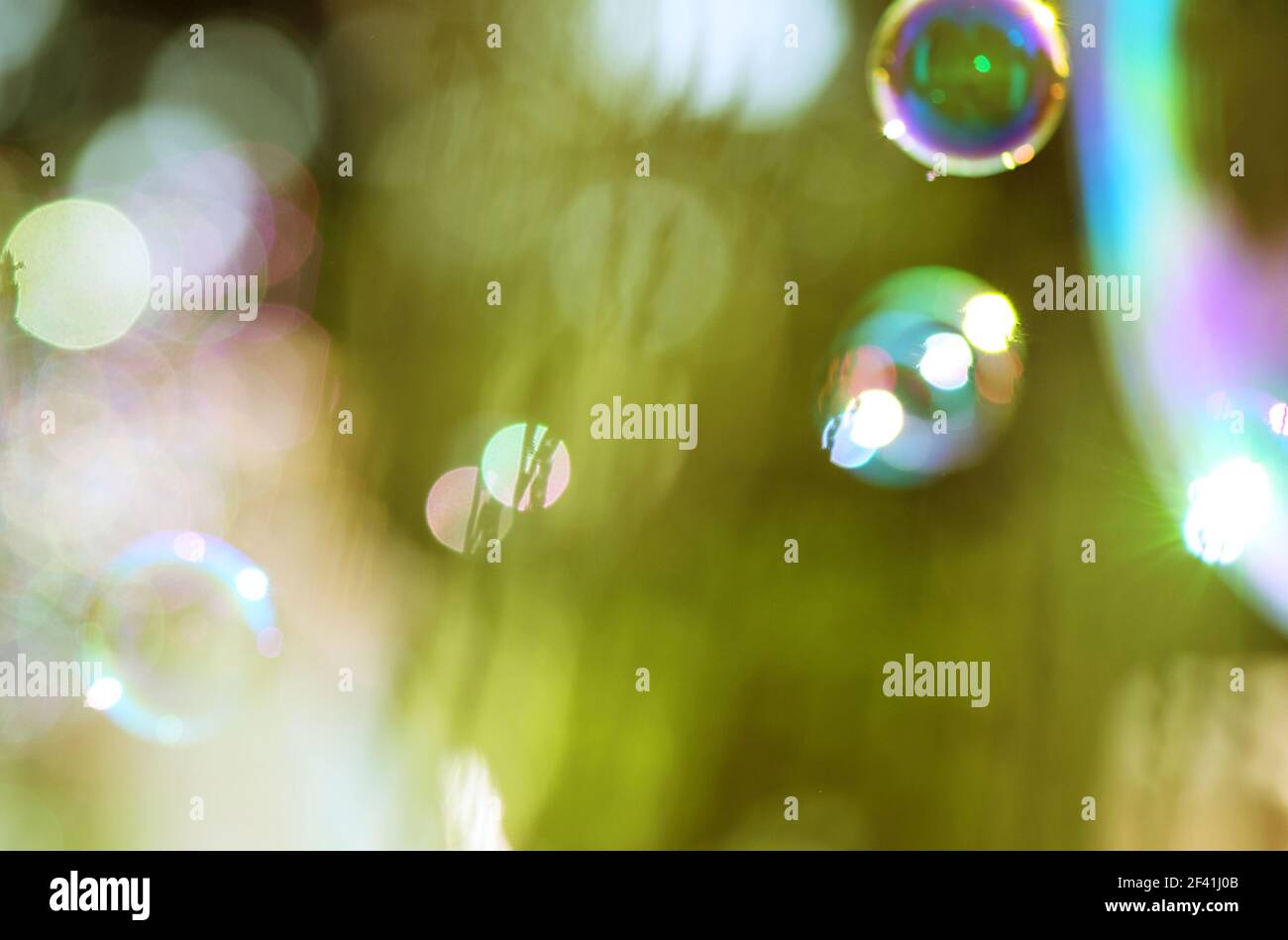 Image of shiny soap bubbles over the green background Stock Photo - Alamy