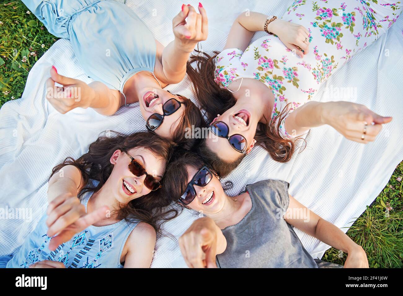 Four cheerful women in a pointing pose Stock Photo - Alamy