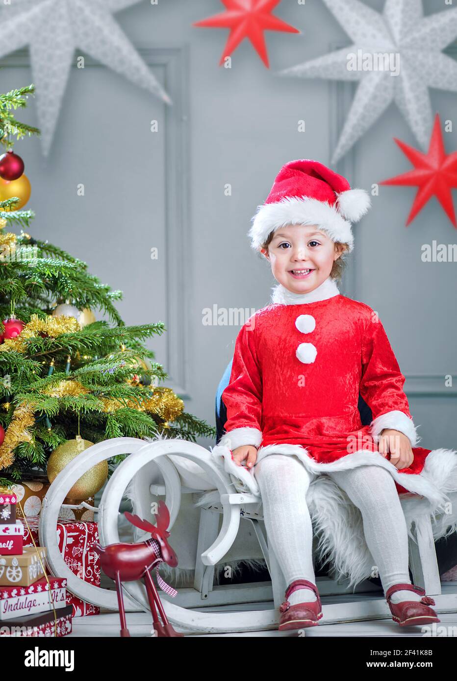 Cute little elf sitting on the Christmas sledge Stock Photo - Alamy