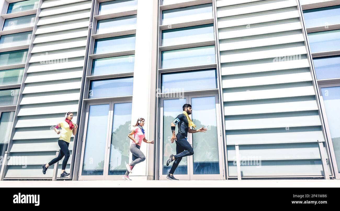 Young people running in modern urban area - Fitness girls running with ...