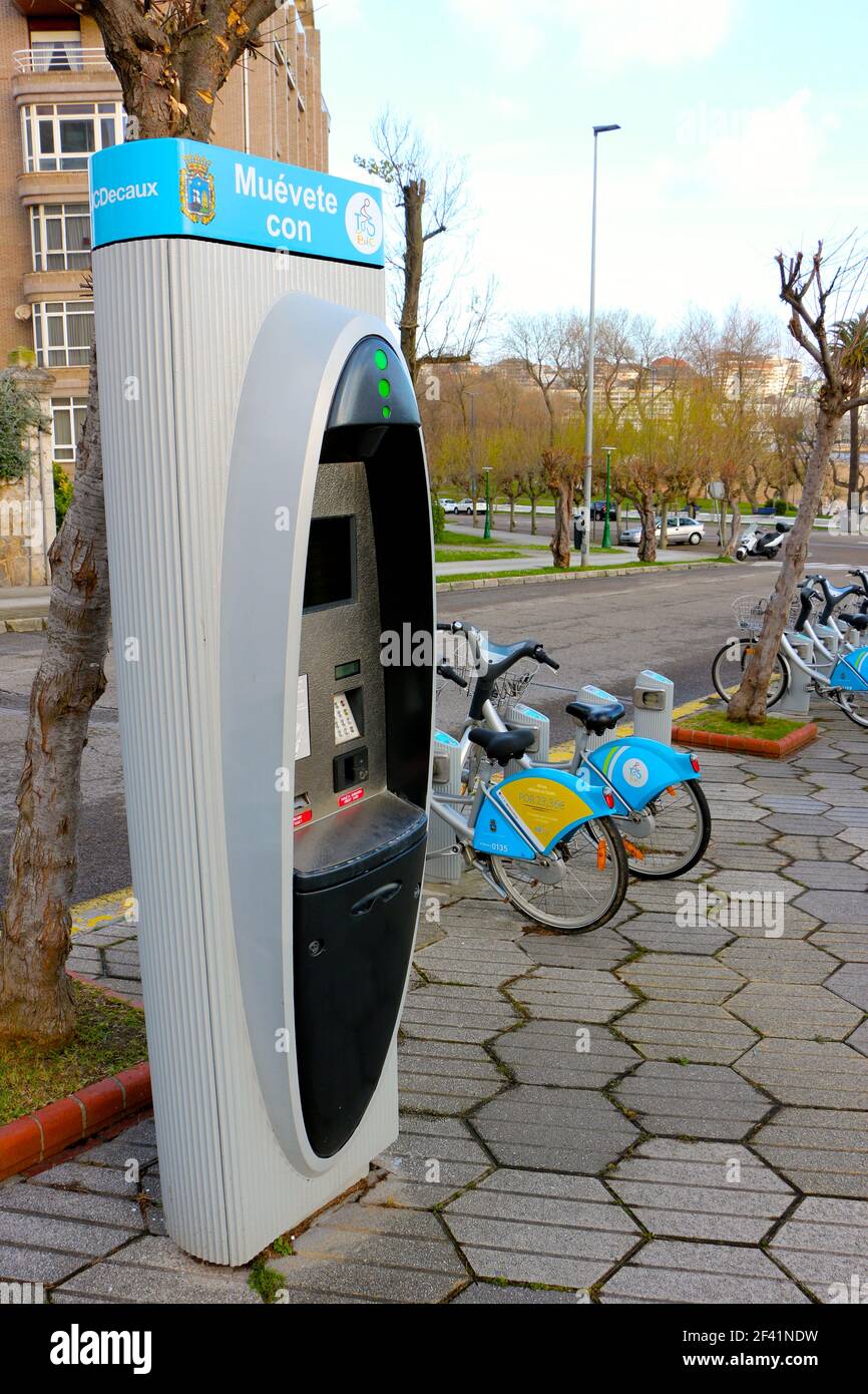 Locked hire bikes parked next to the road in the Plaza de las Brisas ...