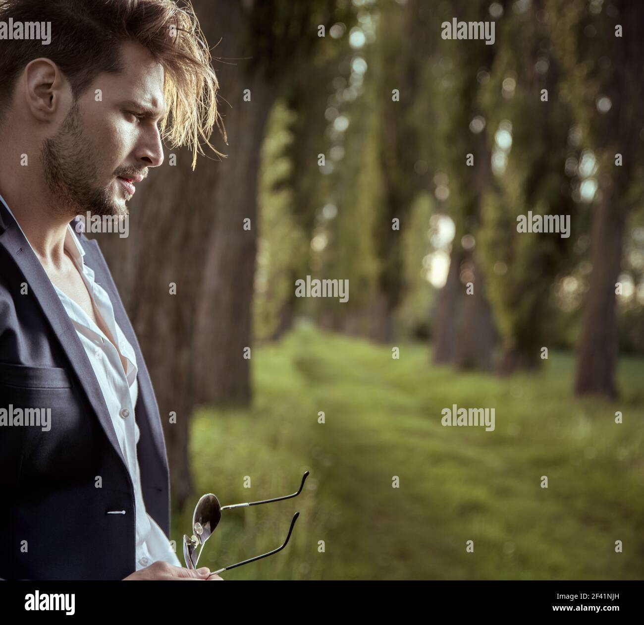 Profile portrait of a tired guy relaxing in the countryside Stock Photo ...
