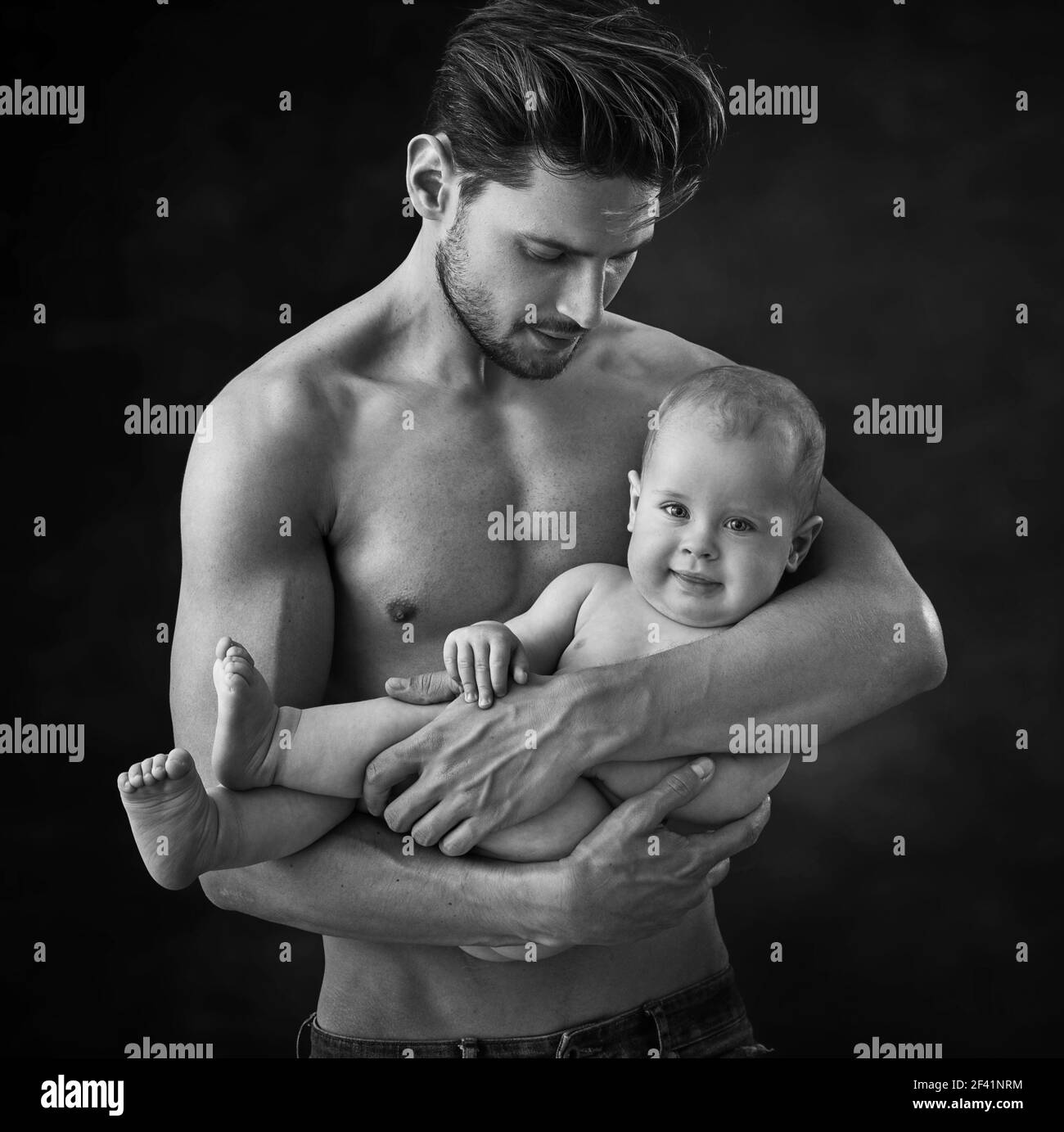 Black&white portrait of a proud father carrying his cute son Stock ...