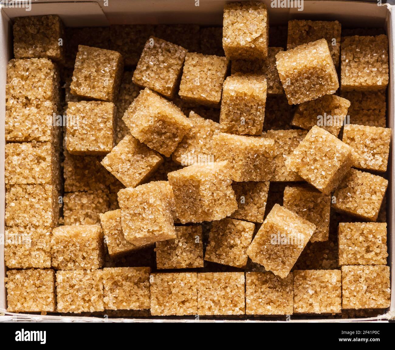 Brown sugar cubes in the paper package. Top view Stock Photo - Alamy