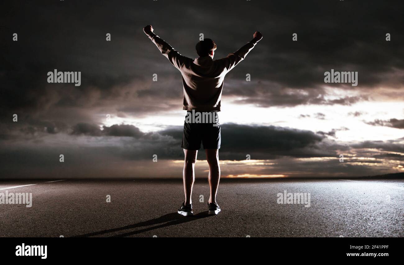 Young athlete looking at the dark sky Stock Photo - Alamy