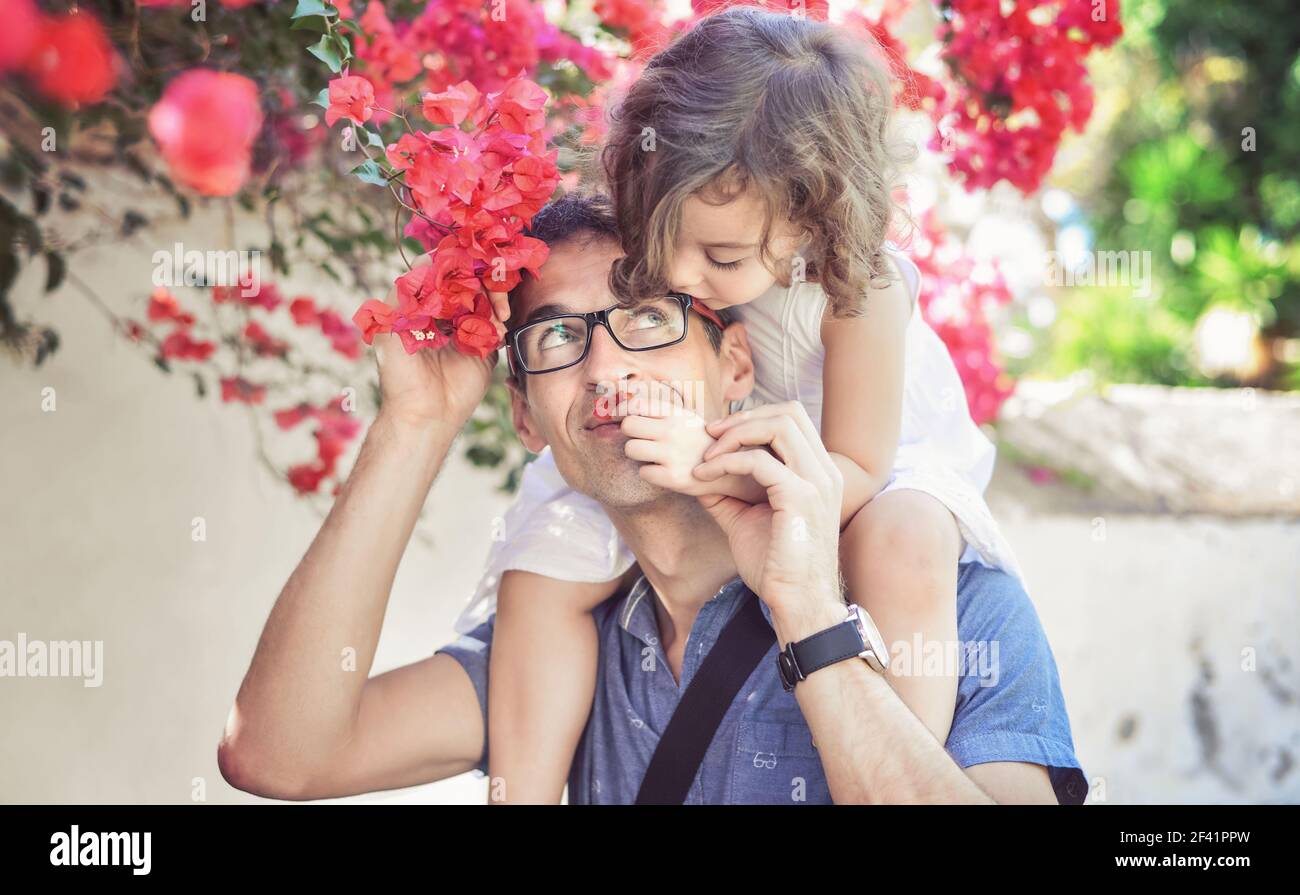 Portrait of a dad carrying his cheerful daughter Stock Photo - Alamy