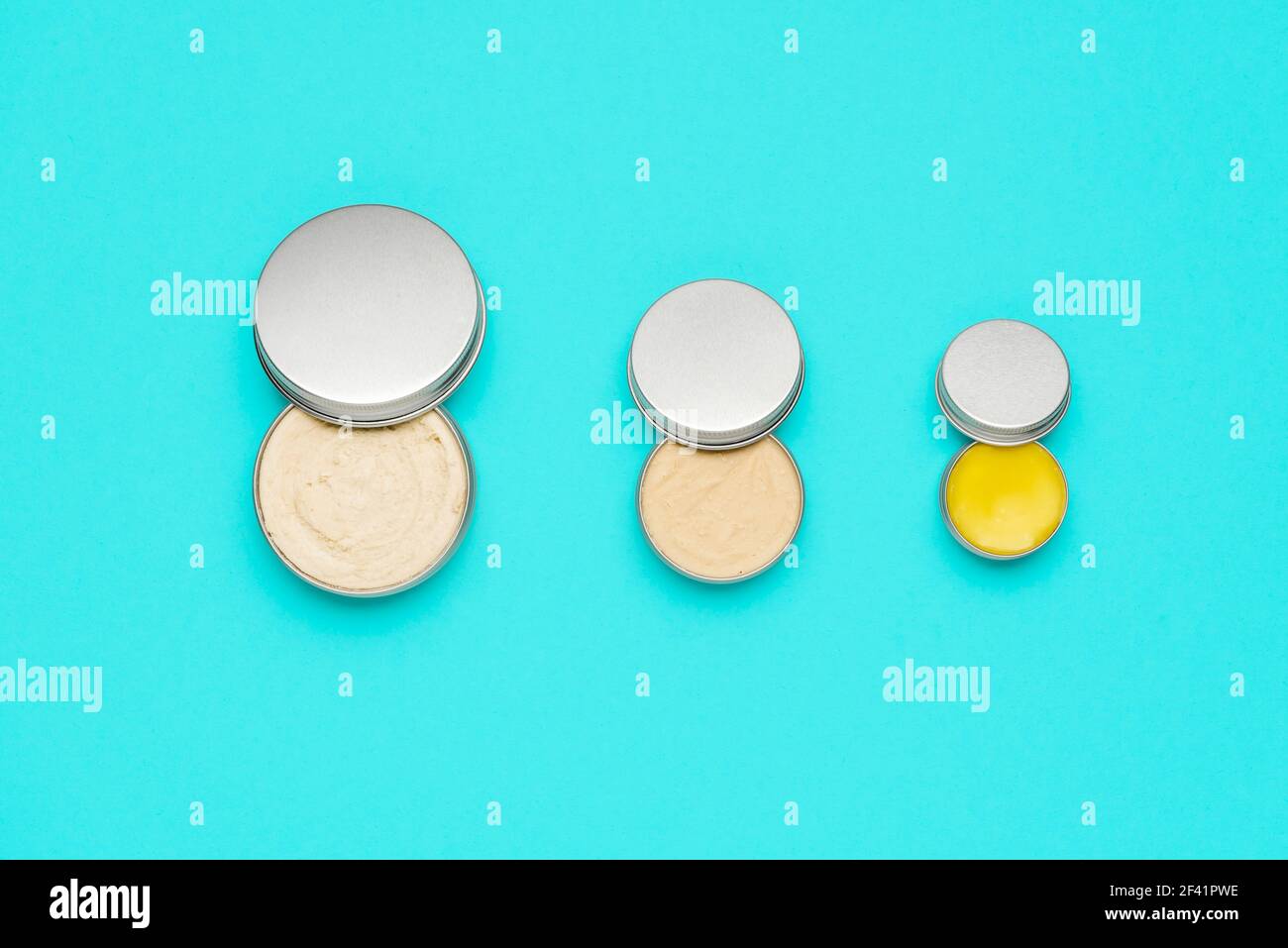 Above view with natural deodorants and cosmetics in metal cans isolated ...