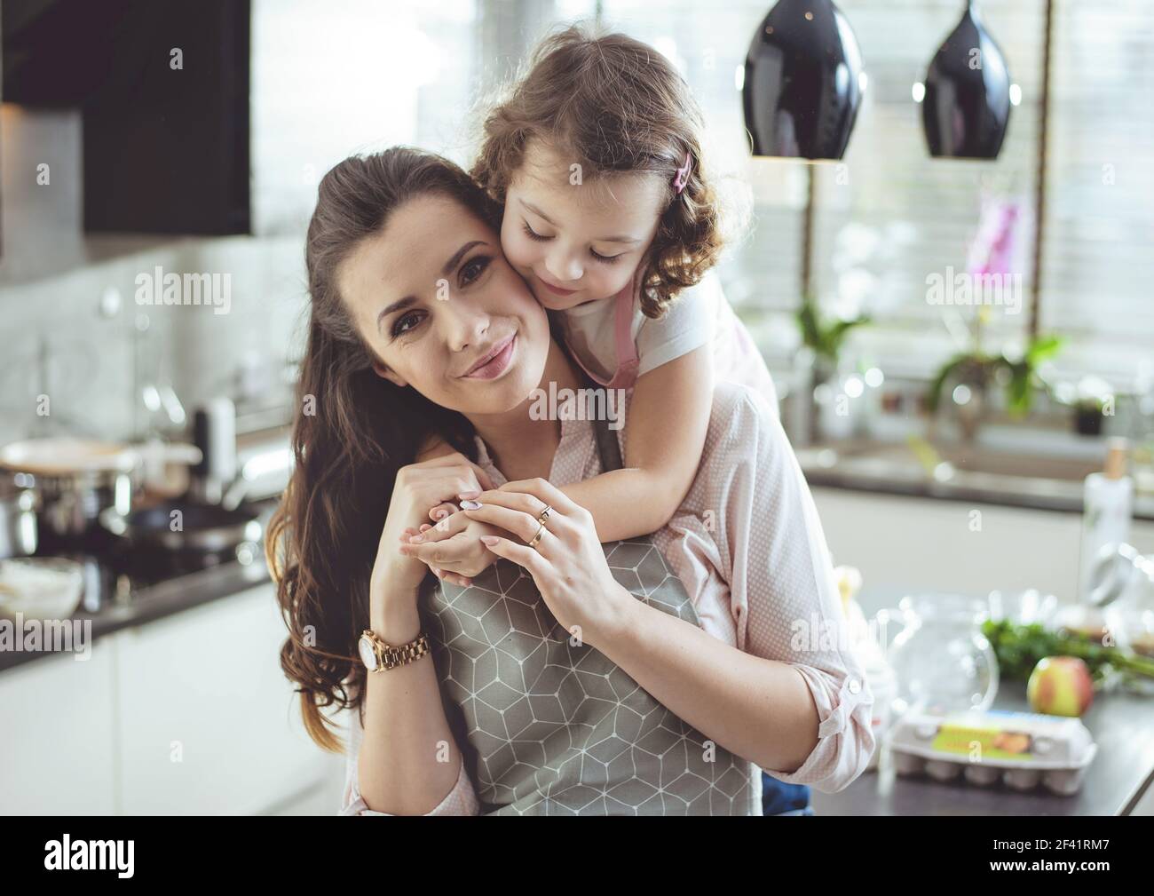 Portrait of a cute daughter hugging her beloved mother Stock Photo - Alamy