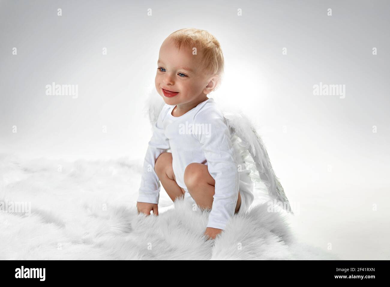 Portrait of a happy little baby angel Stock Photo - Alamy