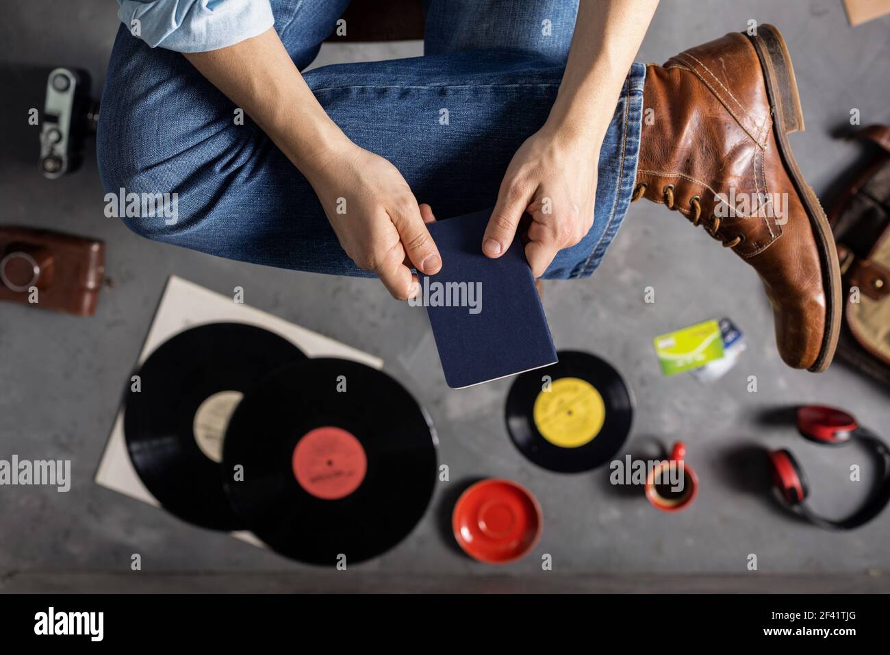 Male hands holding passport or notebook and leg in jeans with old ...
