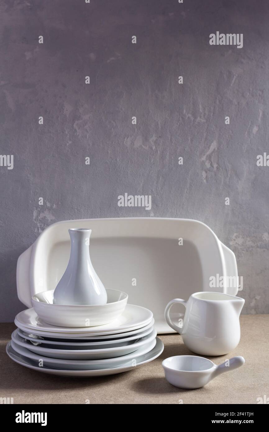 Empty crockery or ceramic dishes set. White kitchen dishware and ...