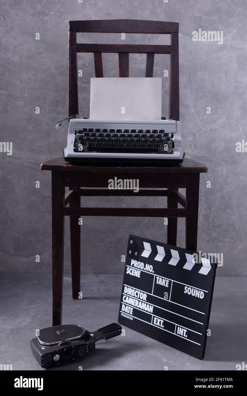 Vintage typewriter at wooden old chair near wall background surface ...
