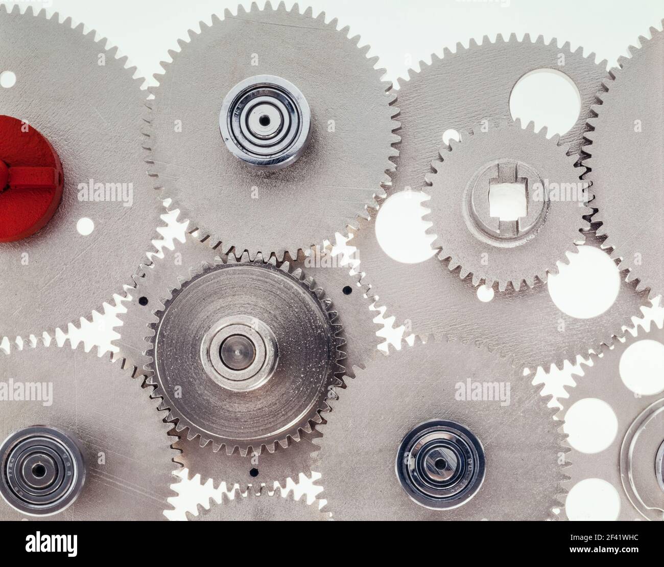 meshed gears on a white plexi background, studio shot, 4x5 film shot ...