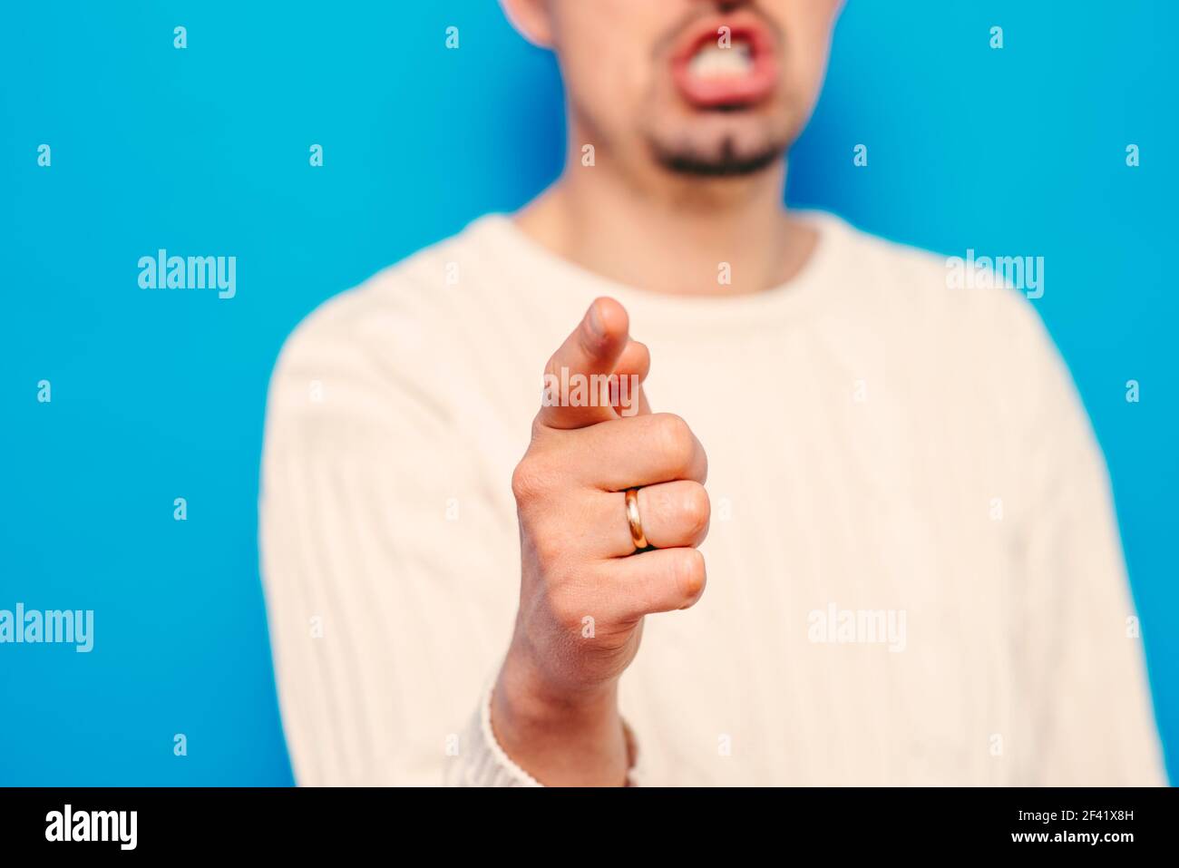 Young man showing his index finger towards the camera Stock Photo - Alamy