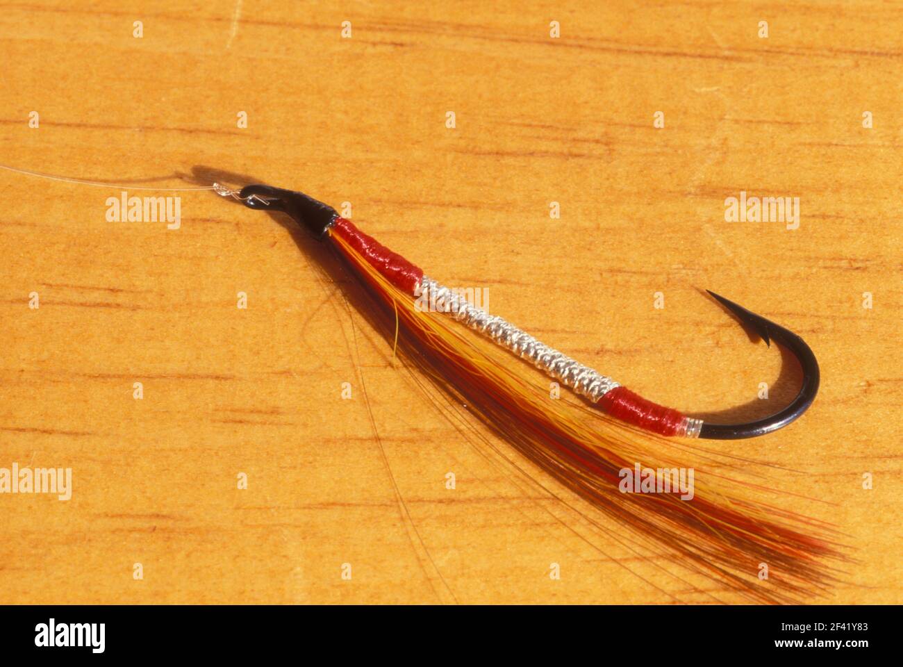 Fly fishing lure, on a table, 35mm film shot Stock Photo - Alamy