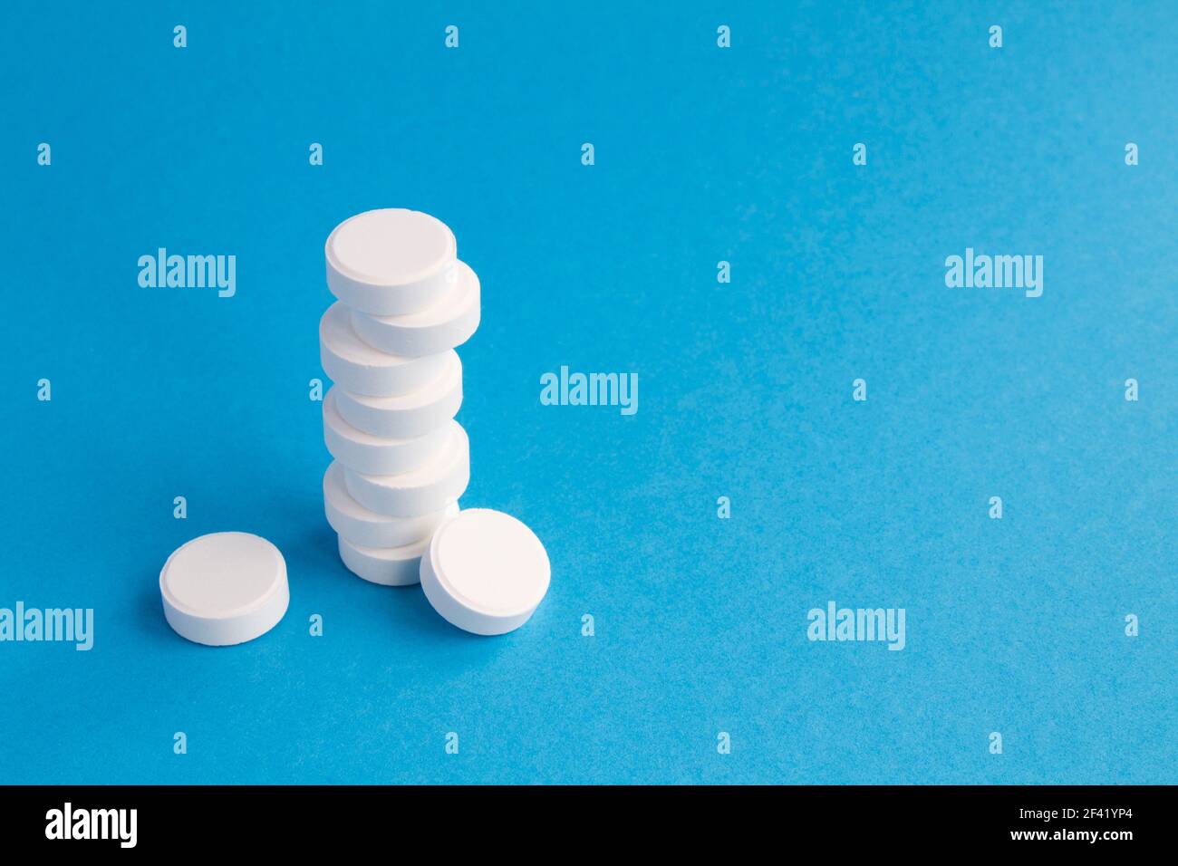 White big pills on the blue background. Copy space. Closeup Stock Photo ...