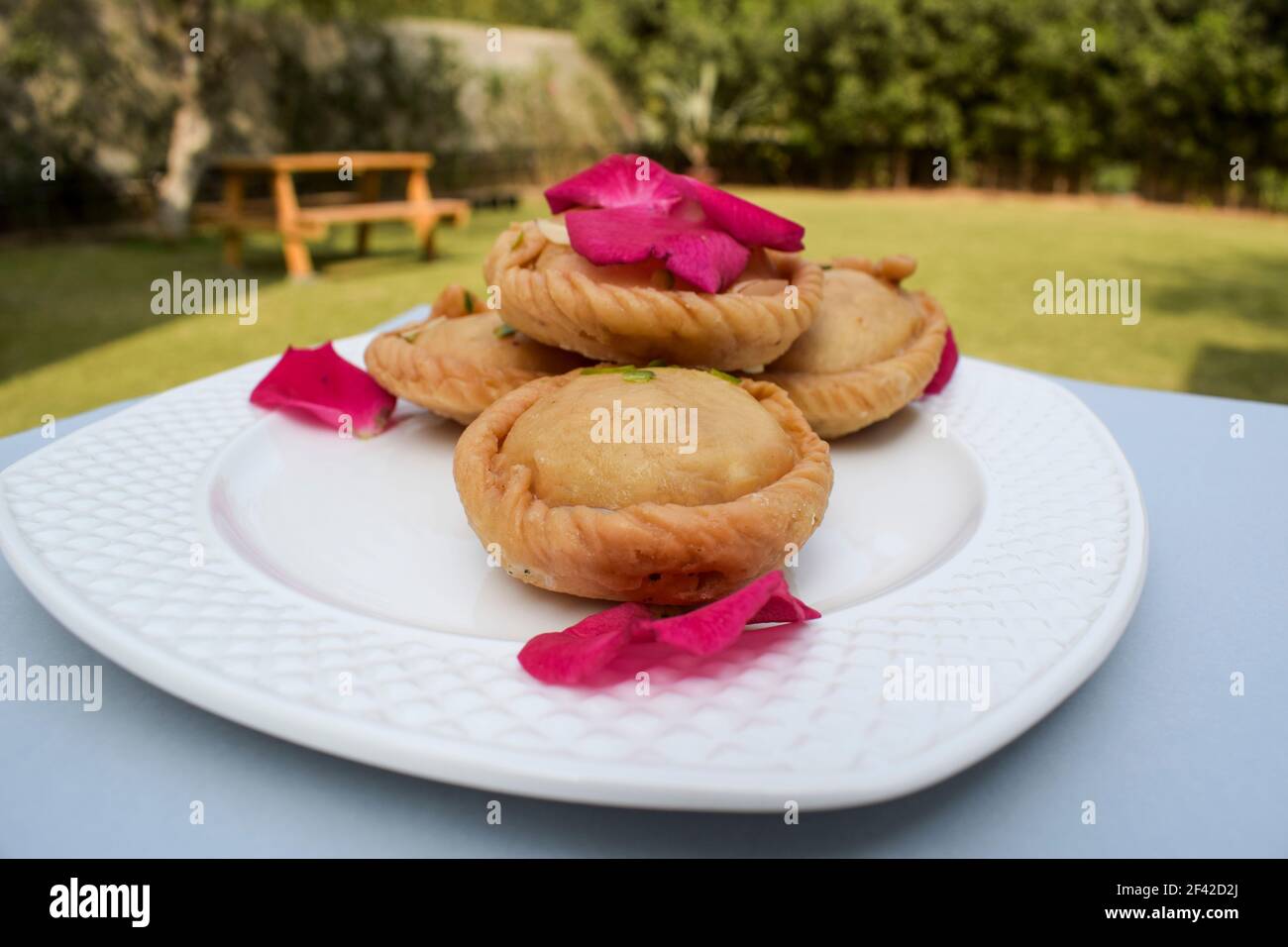 Indian traditional sweet known as Chandrakala, round deep fried sweet ...