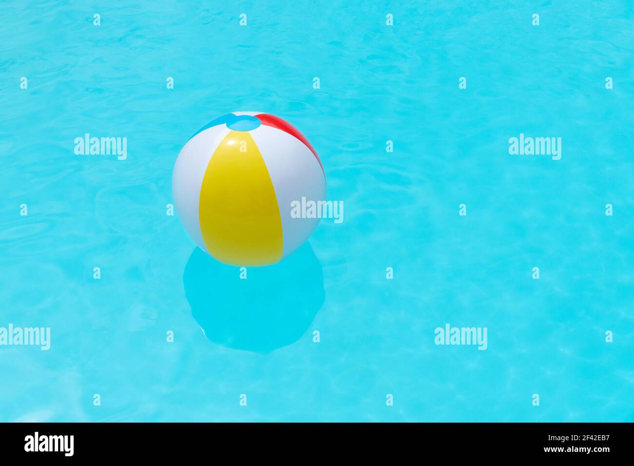 Beach Ball Floating on water surface of a swimming pool. Summer ...