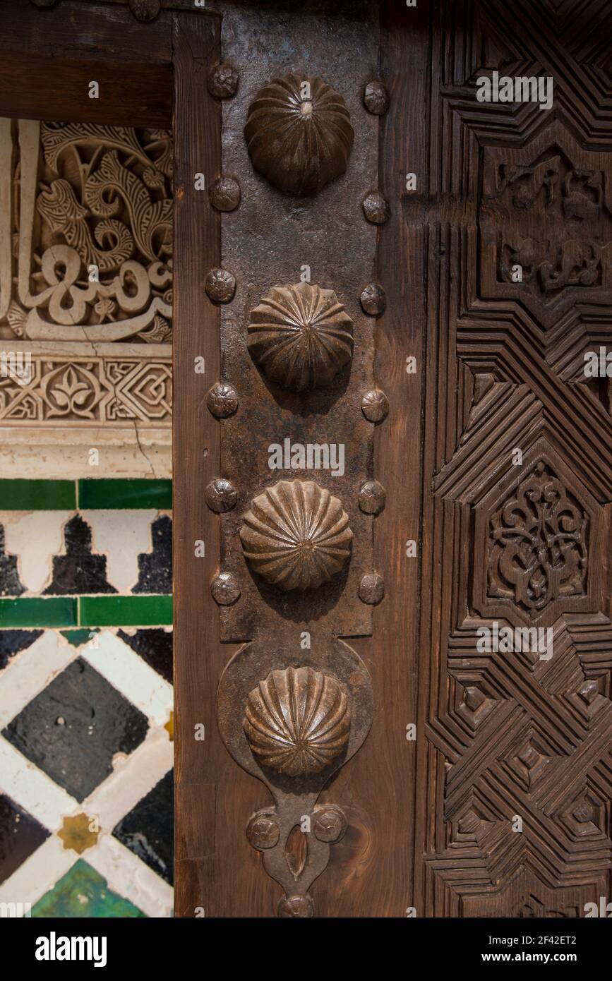 Islamic carving on wall and wooden door in the Alhambra Stock Photo - Alamy