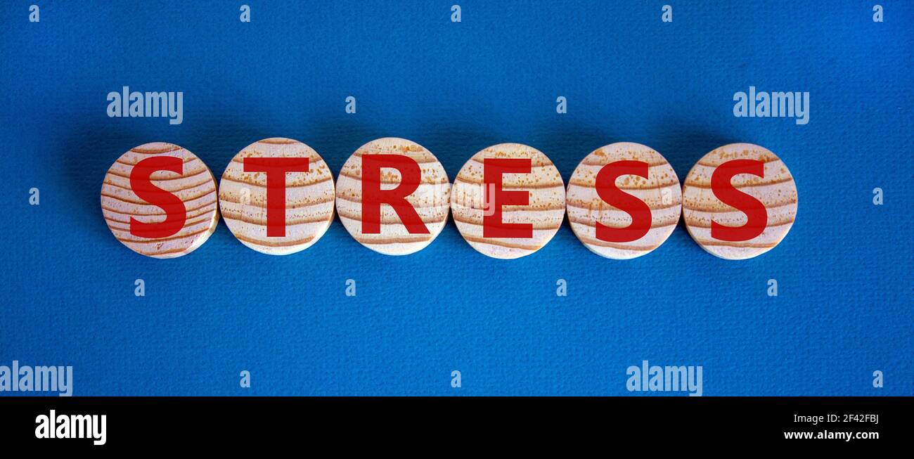 Stop stress and be health symbol. Wooden circles with the word 'stress ...