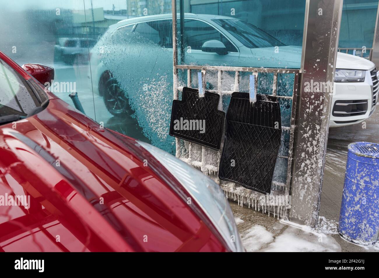 washing car at autowash . Car wash. red machine under the pressure of ...