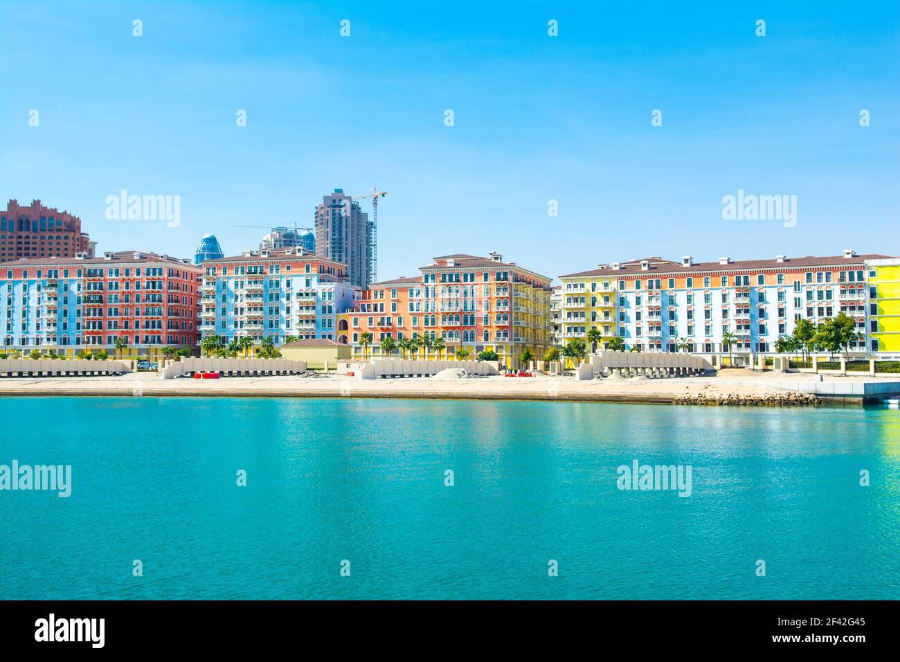 Colorful waterfront buildings in venetian style of the Qanat Quartier ...