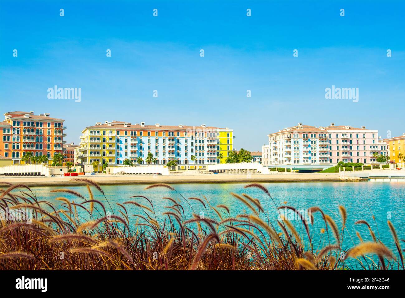 Colorful waterfront buildings in venetian style of the Qanat Quartier ...