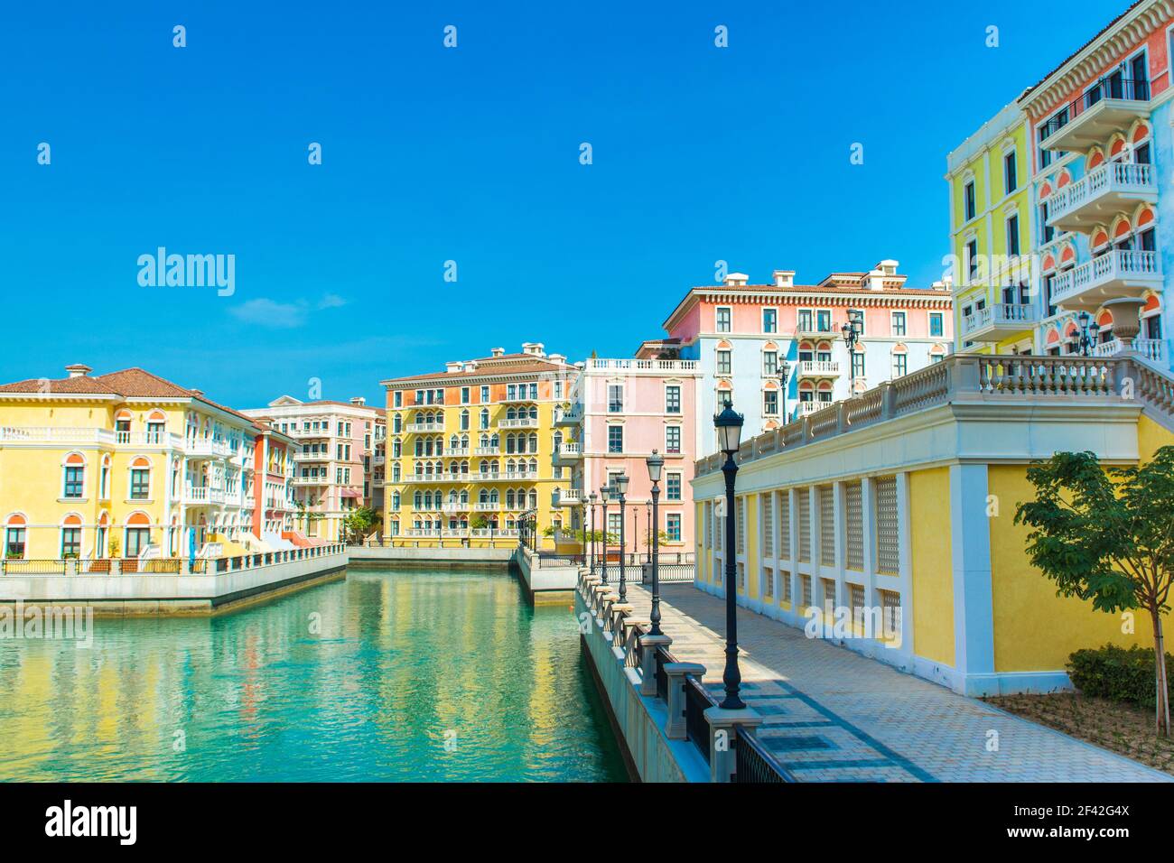 Colorful waterfront buildings in venetian style in the Qanat Quartier ...