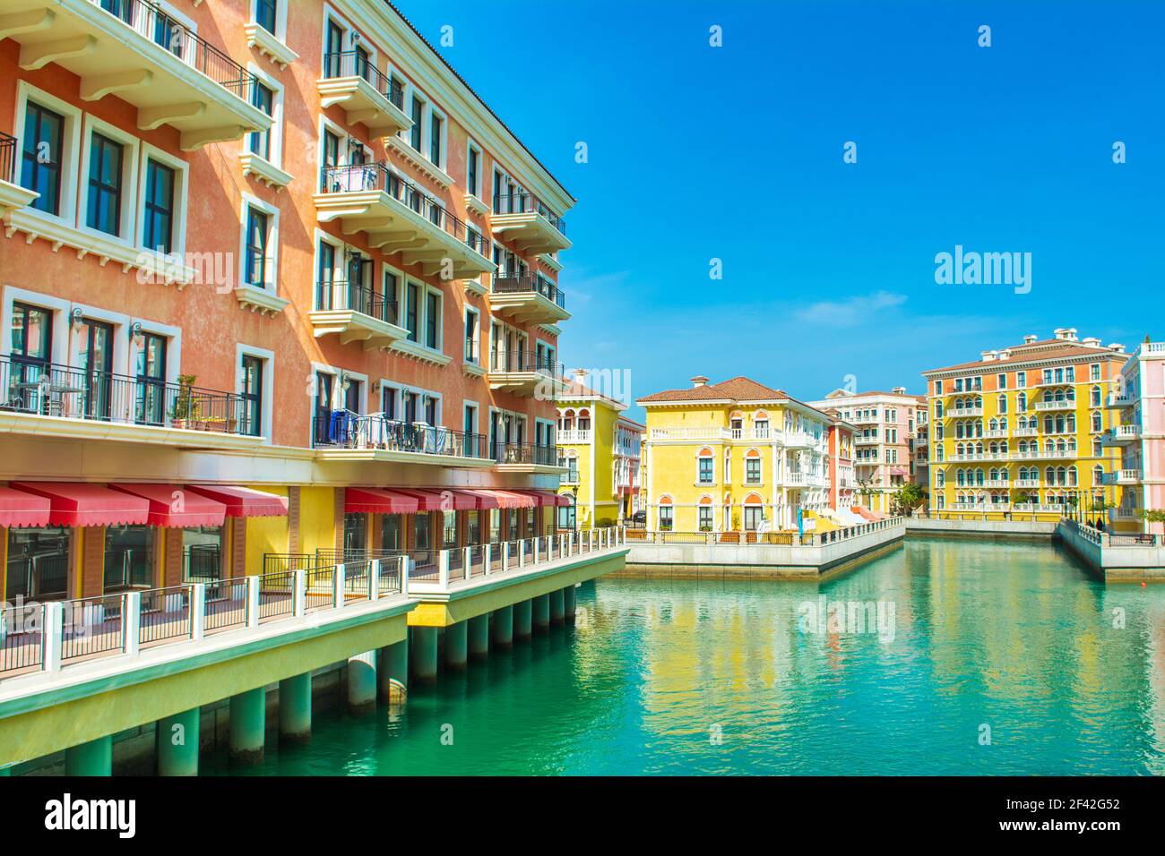 Colorful waterfront buildings in venetian style in the Qanat Quartier ...