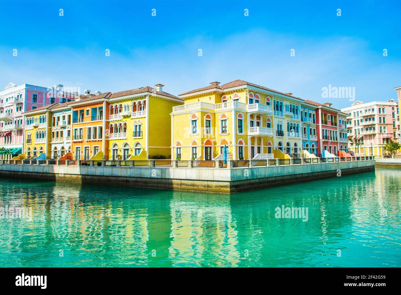 Colorful waterfront buildings in venetian style in the Qanat Quartier ...