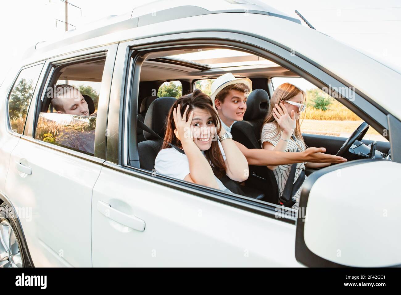 four friends in car navigation on phone. road trip Stock Photo - Alamy