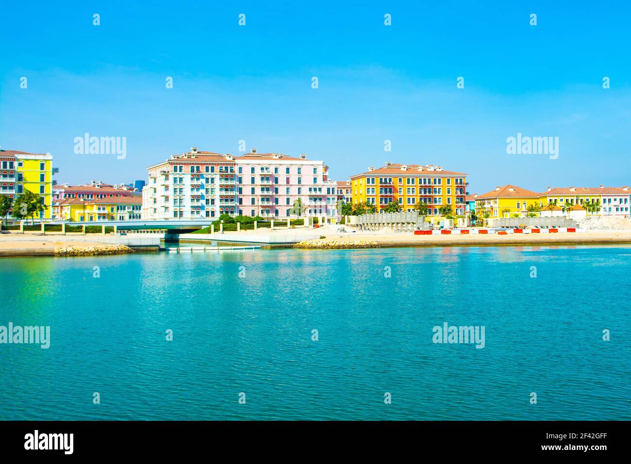 Colorful waterfront buildings in venetian style of the Qanat Quartier ...
