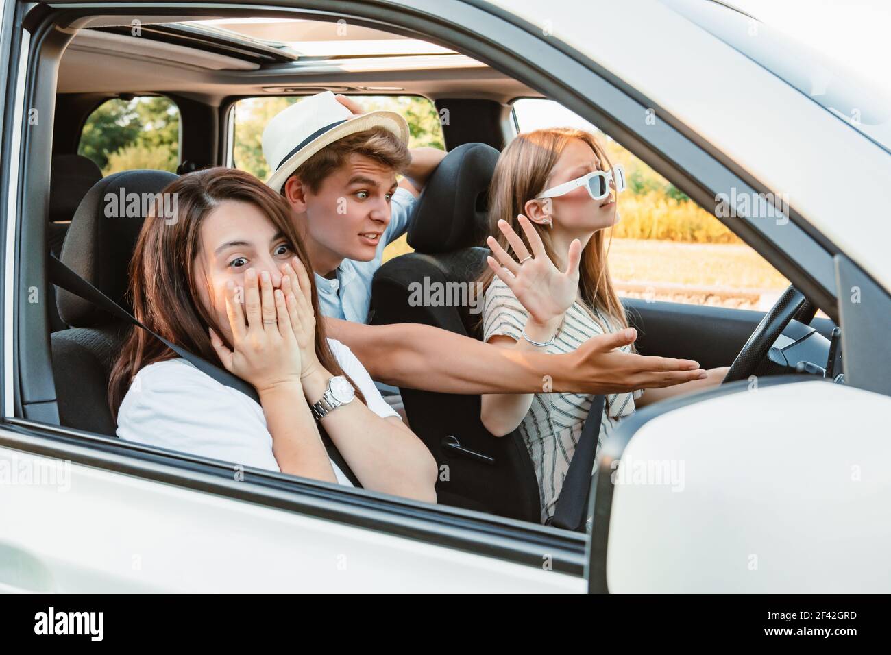 four friends in car navigation on phone. road trip Stock Photo - Alamy