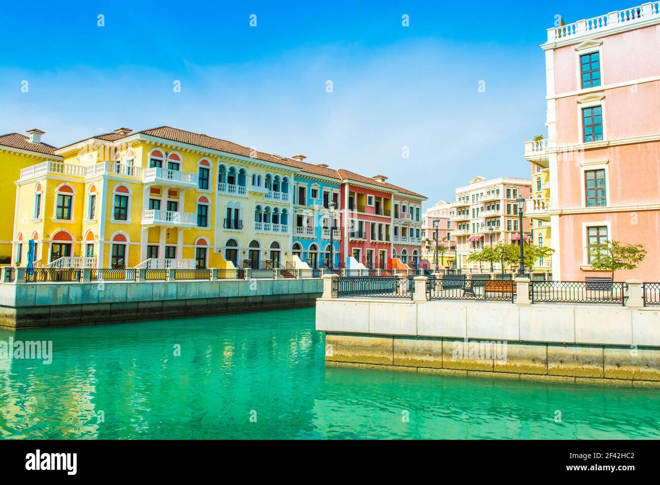 Colorful waterfront buildings in venetian style in the Qanat Quartier ...