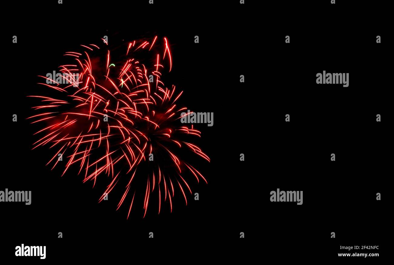 Closeup of fireworks in the sky. Red streamers. Short exposure that ...