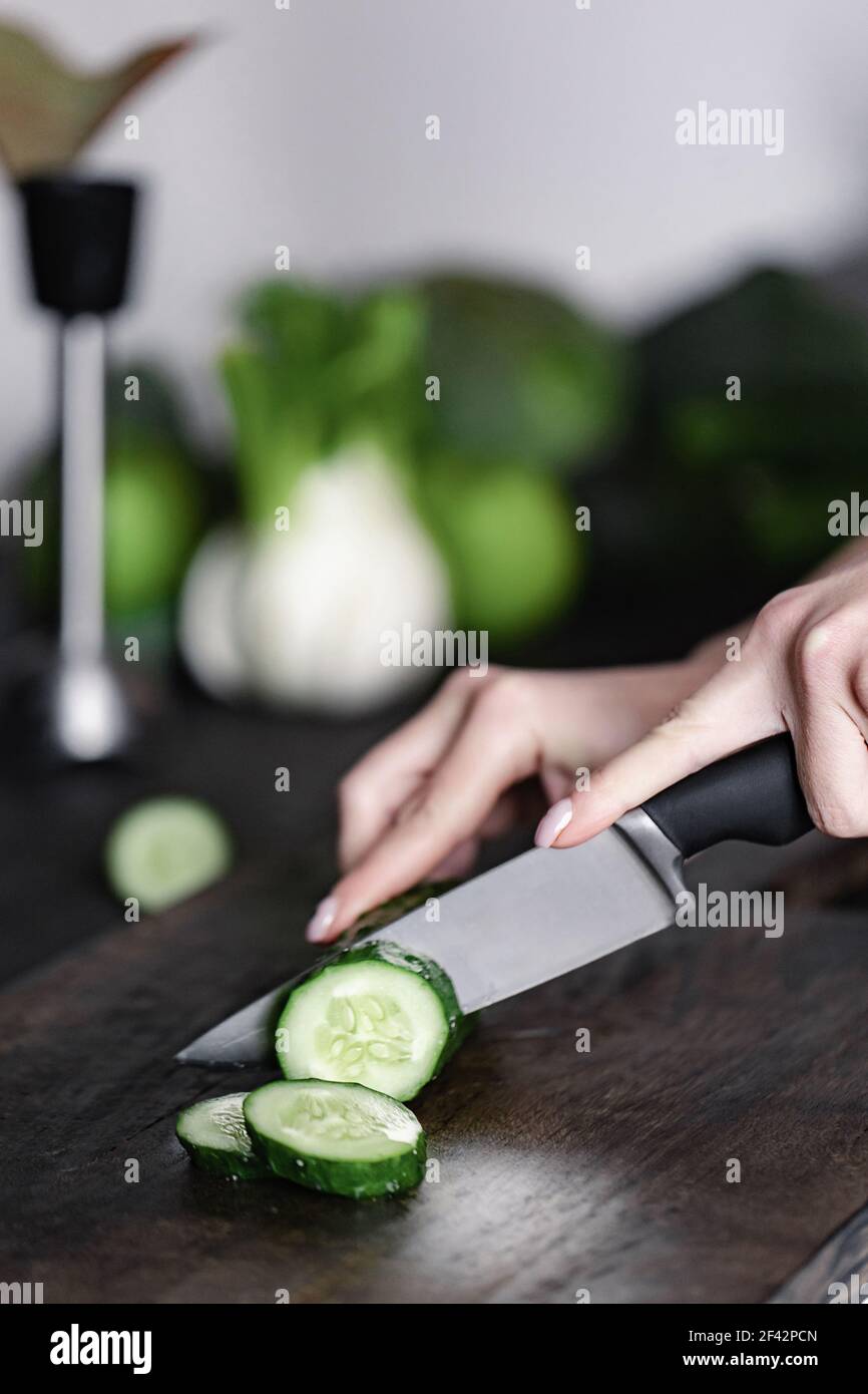 Woman chopping cucumber hi-res stock photography and images - Alamy