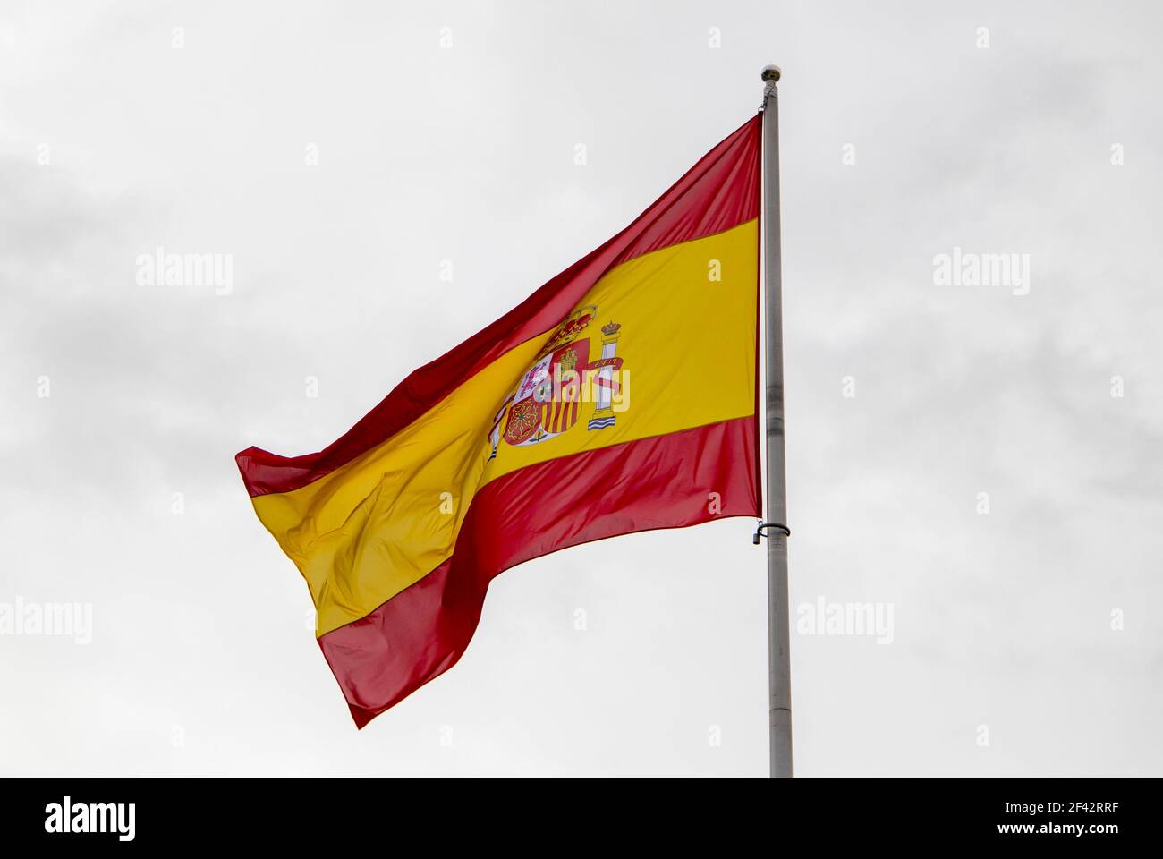 Flag of Spain waving on white sky Stock Photo - Alamy