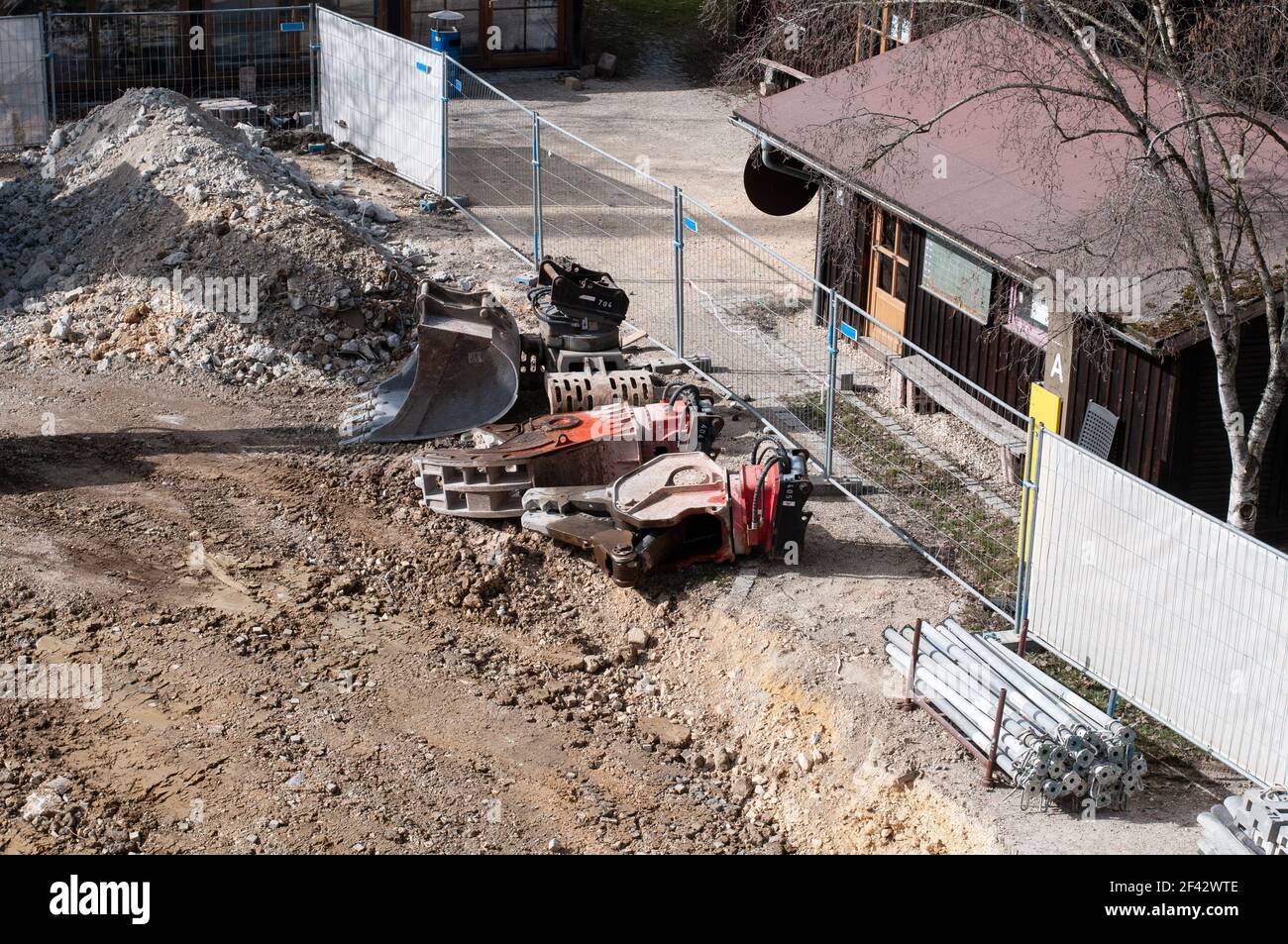 view over a construction site with concrete breakers and digger buckets ...