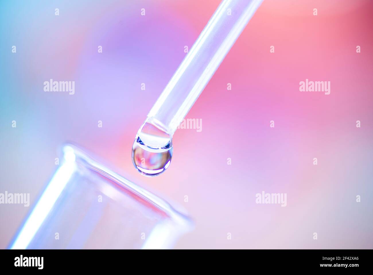 Close up of chemical test tube and pipette with drop of colorless ...
