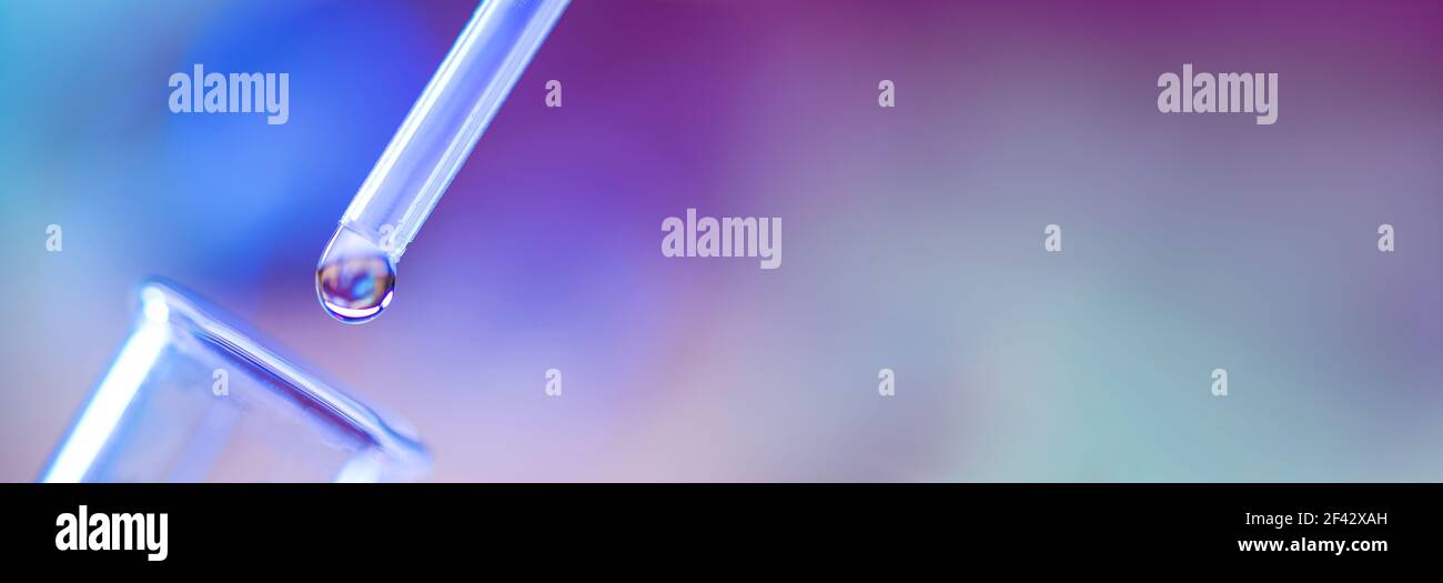 Close up of chemical test tube and pipette with drop of colorless ...