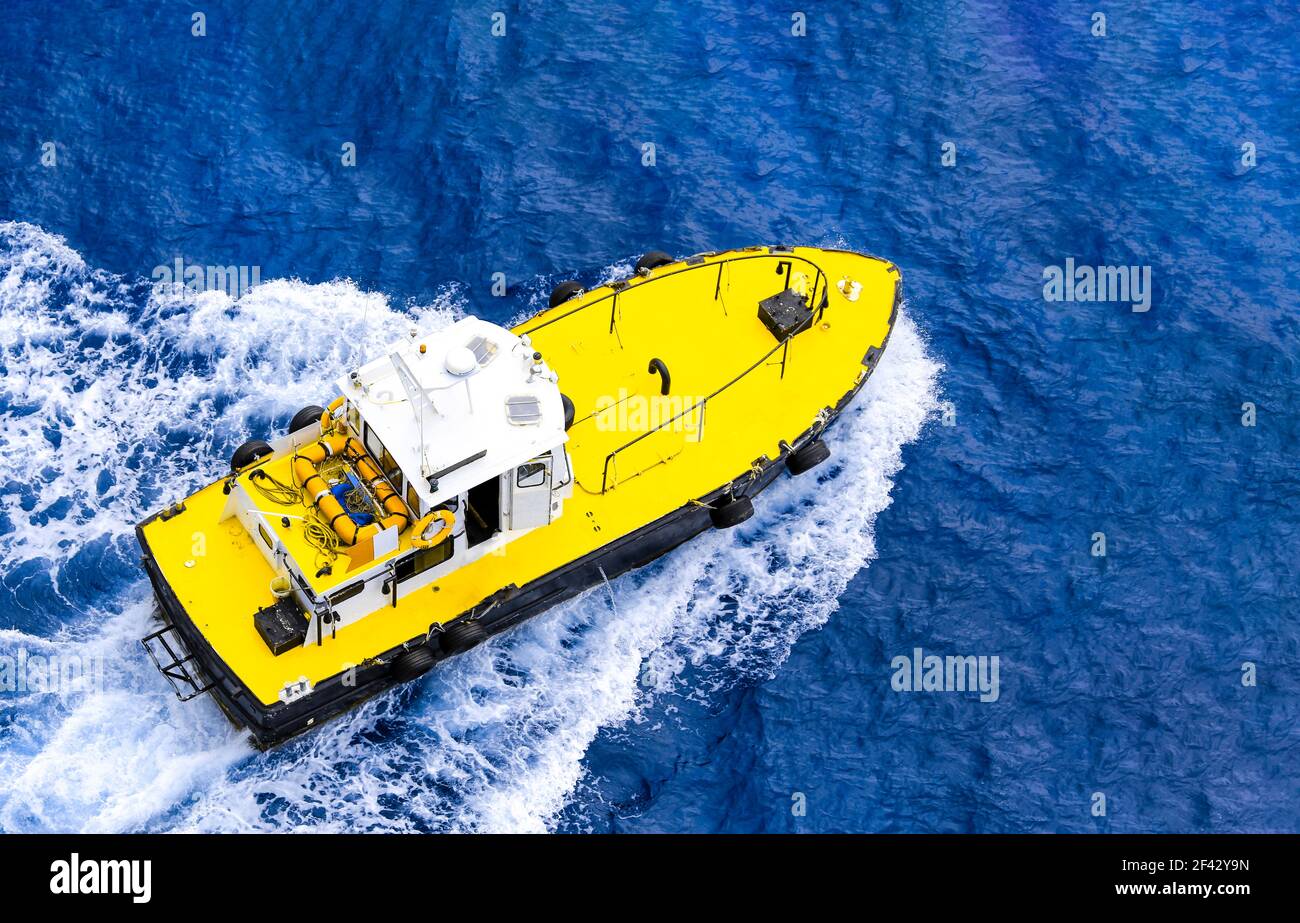 Cruise ship guide boat sailing the blue waters of the ocean in the ...