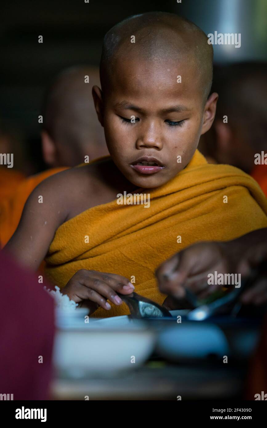 Novice monk eating lunch at Ko Yin Lay Monastery near Kengtung, Myanmar ...