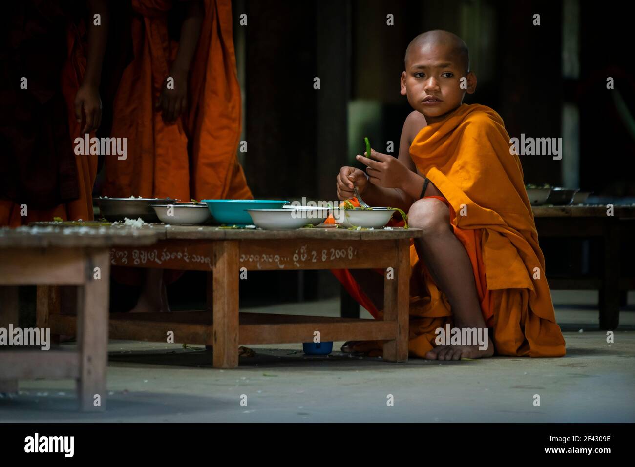 Novice monk eating lunch at Ko Yin Lay Monastery, Kengtung, Myanmar ...