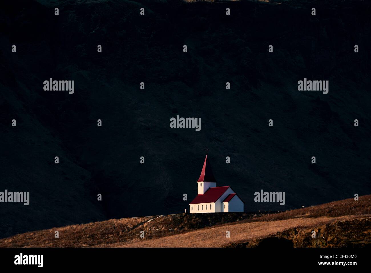 Church near dark mountain slope Stock Photo - Alamy