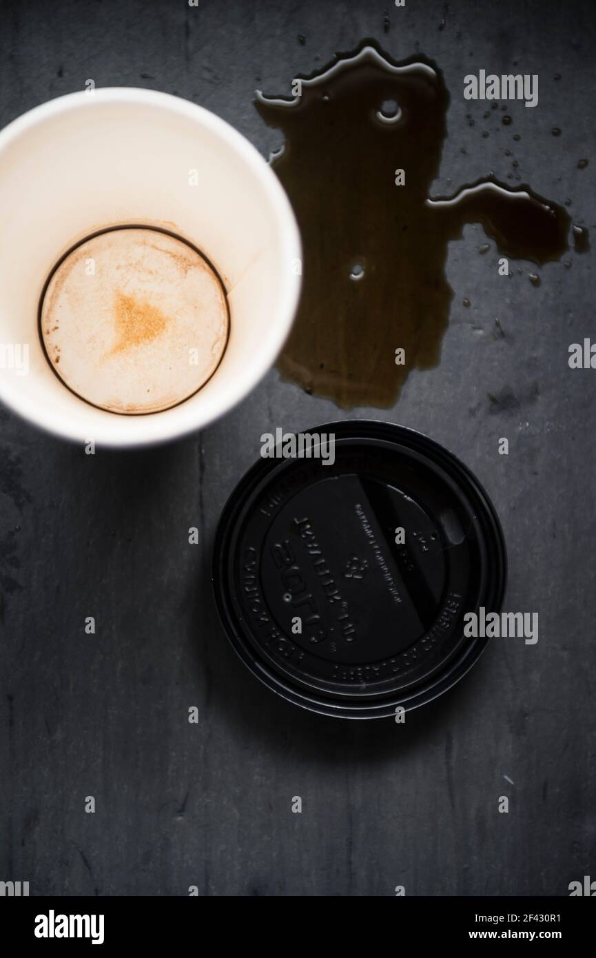 Spilled Coffee with Empty Paper Coffee Cup and Lid on Black Background ...