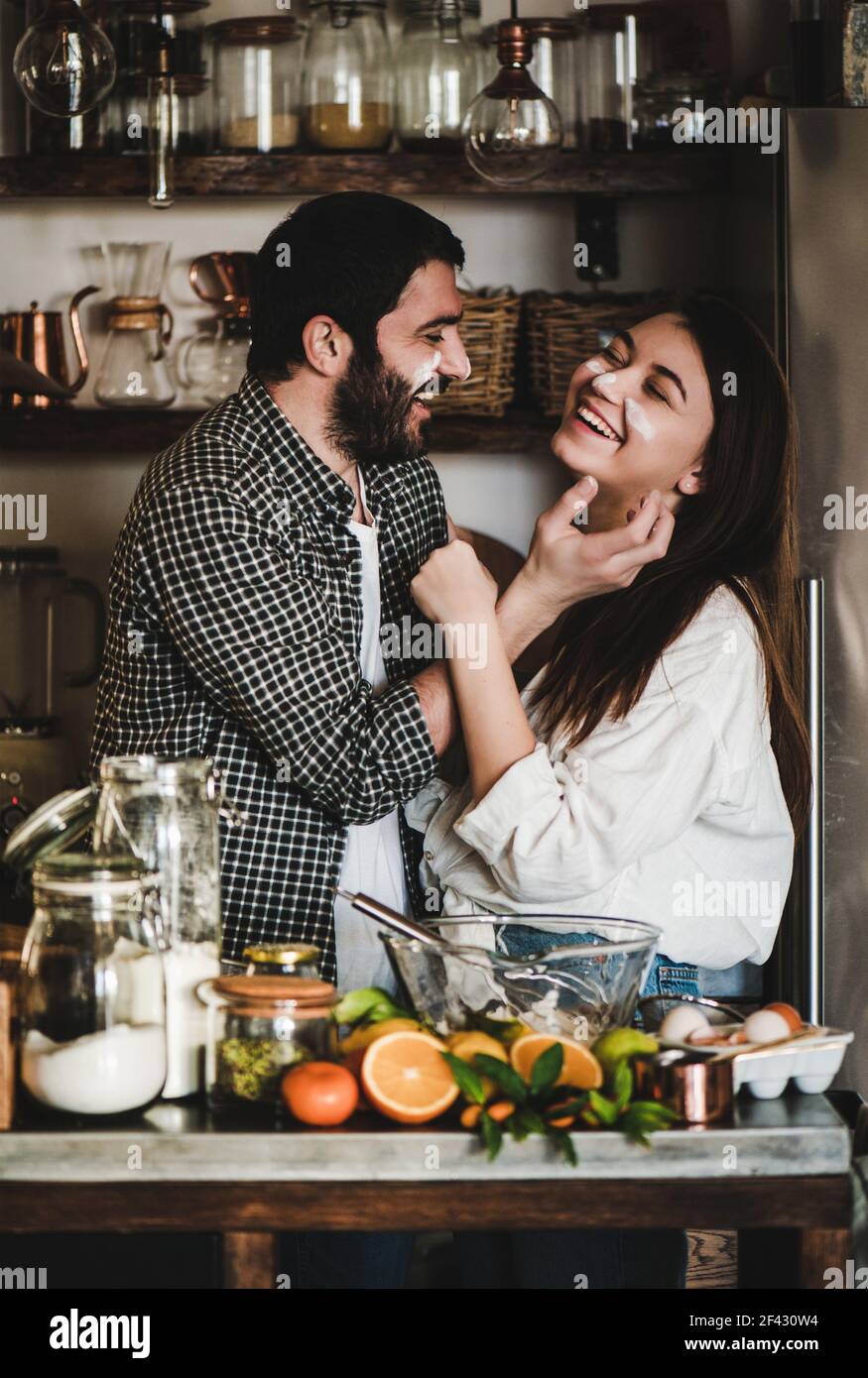 Sweet family couple having fun during cooking together Stock Photo - Alamy