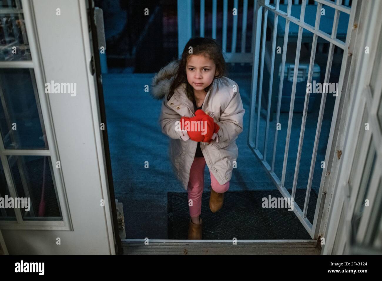 Child coming inside in evening after playing in cold weather Stock ...