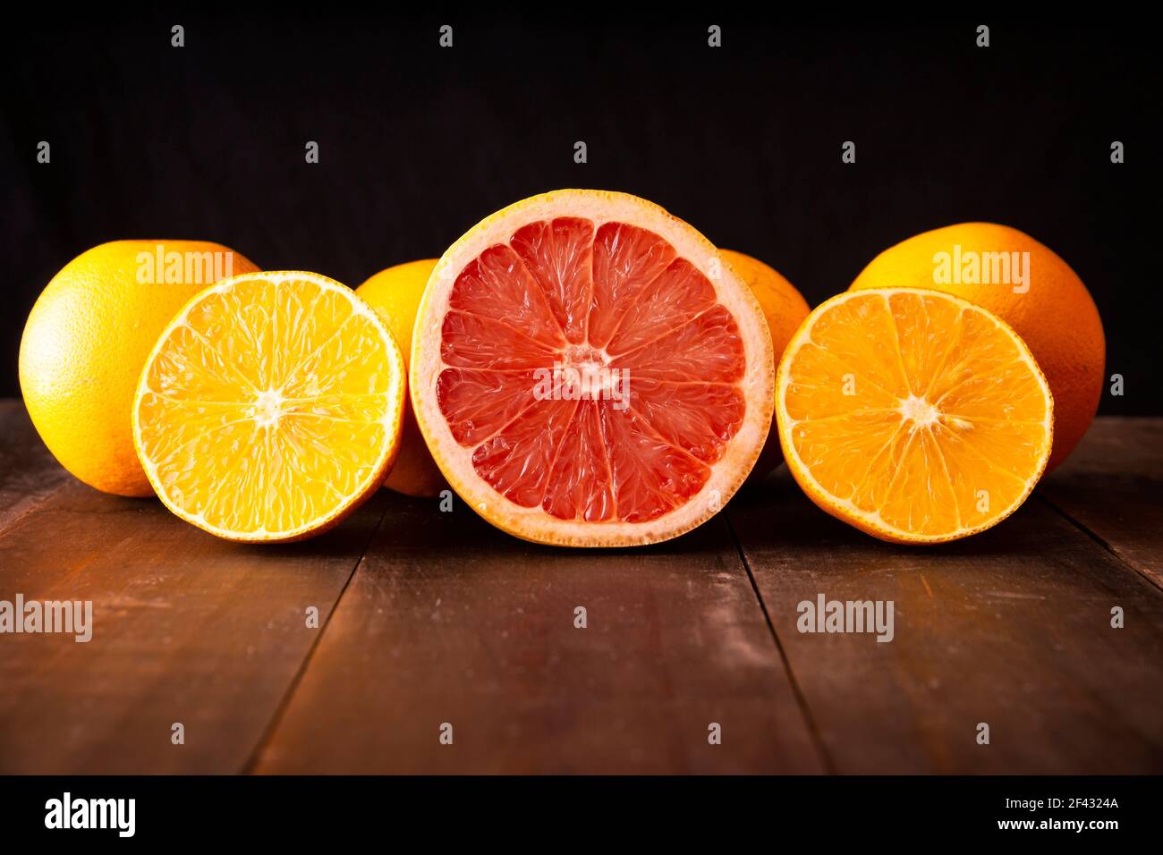 close up image of ripe orange and grapefruit slices and several whole ...